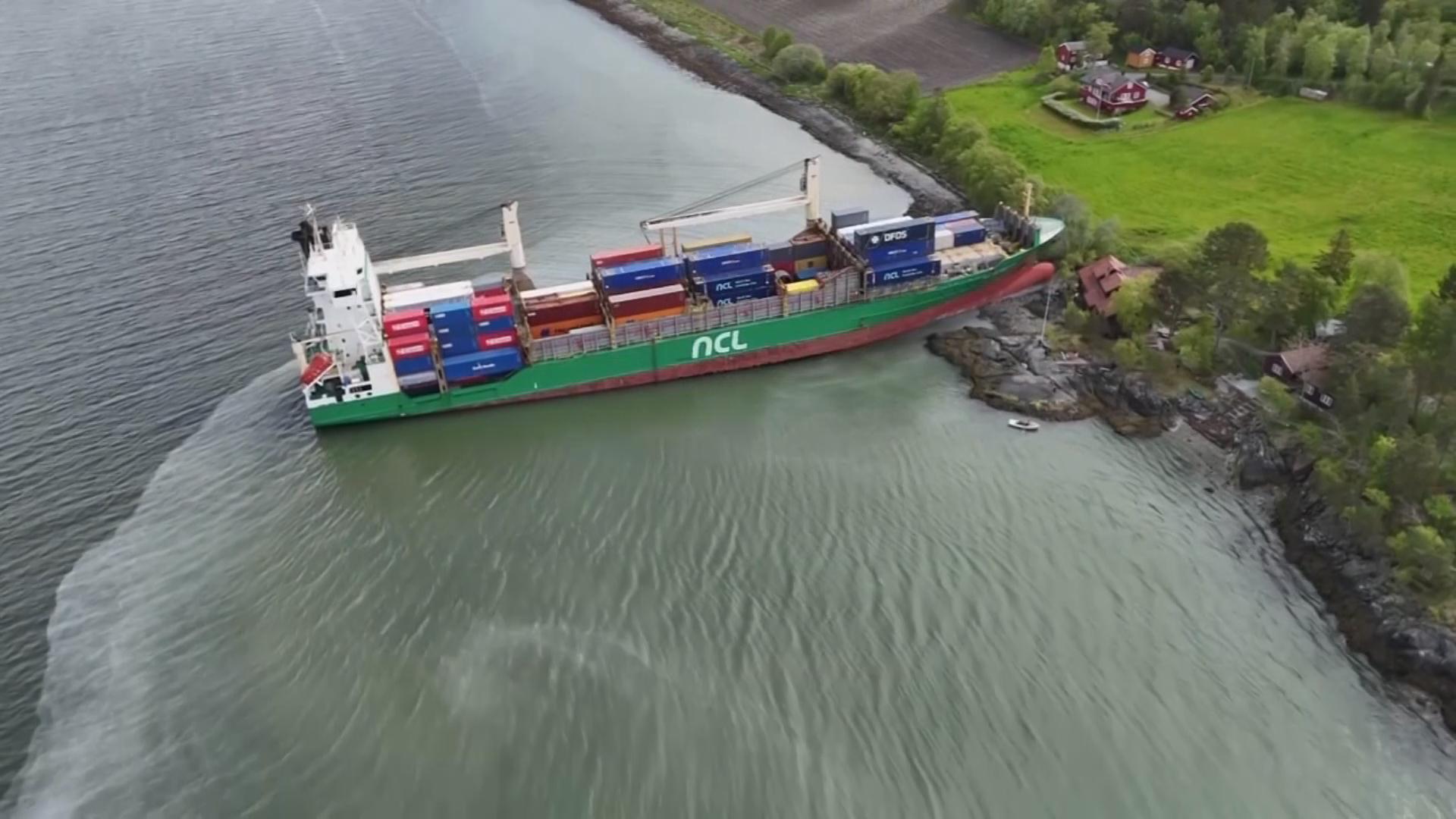 Container ship runs aground near Norwegian seaside home
