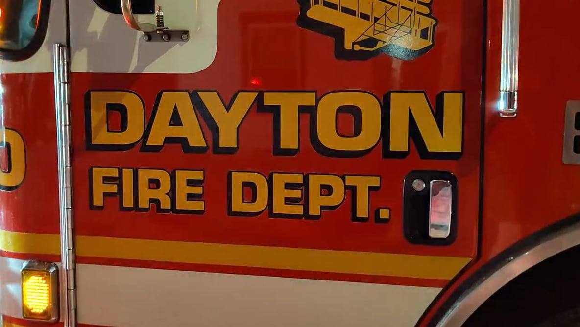 Man taken into custody after house fire in Dayton neighborhood