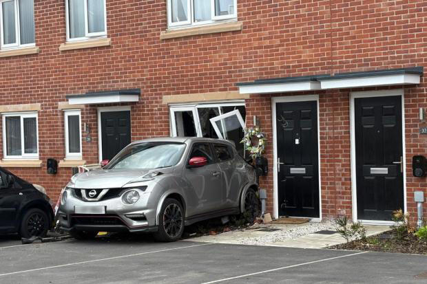 Car 'deliberately' reversed into house multiple times, police say