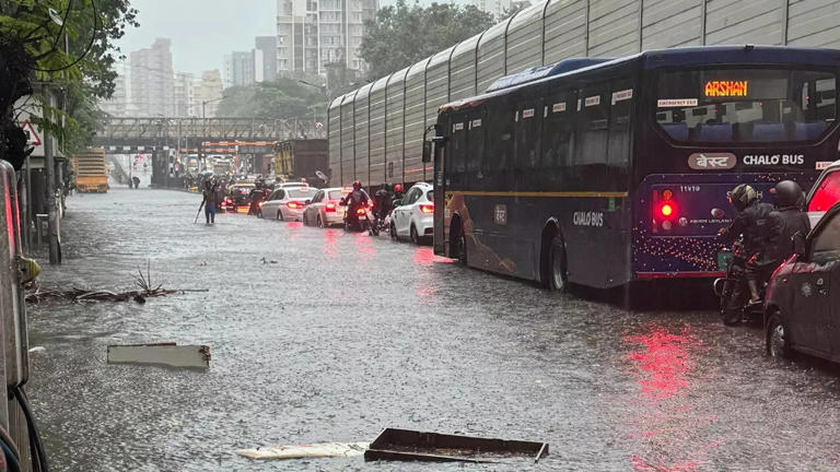 Trains crawl, roads waterlogged, buses diverted as Mumbai reels under heavy rain; 'orange' alert ...