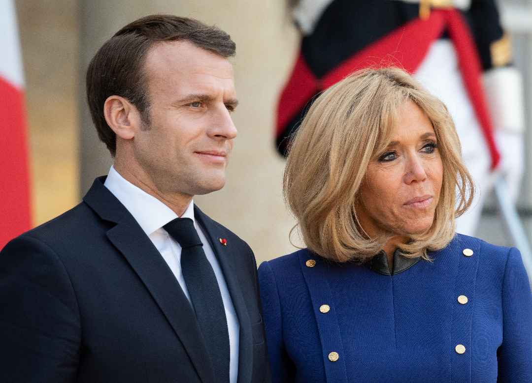 Watch French president Emmanuel Macron's wife grab his face and shove him