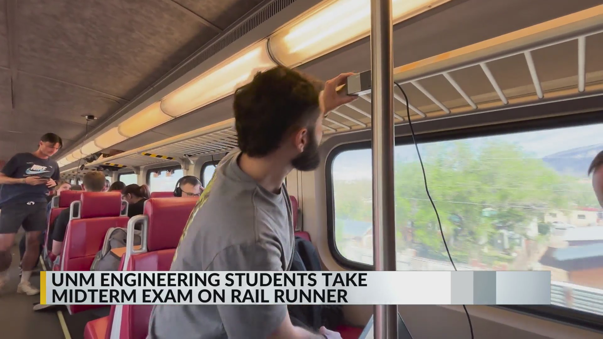UNM engineering students take midterm exam on Rail Runner