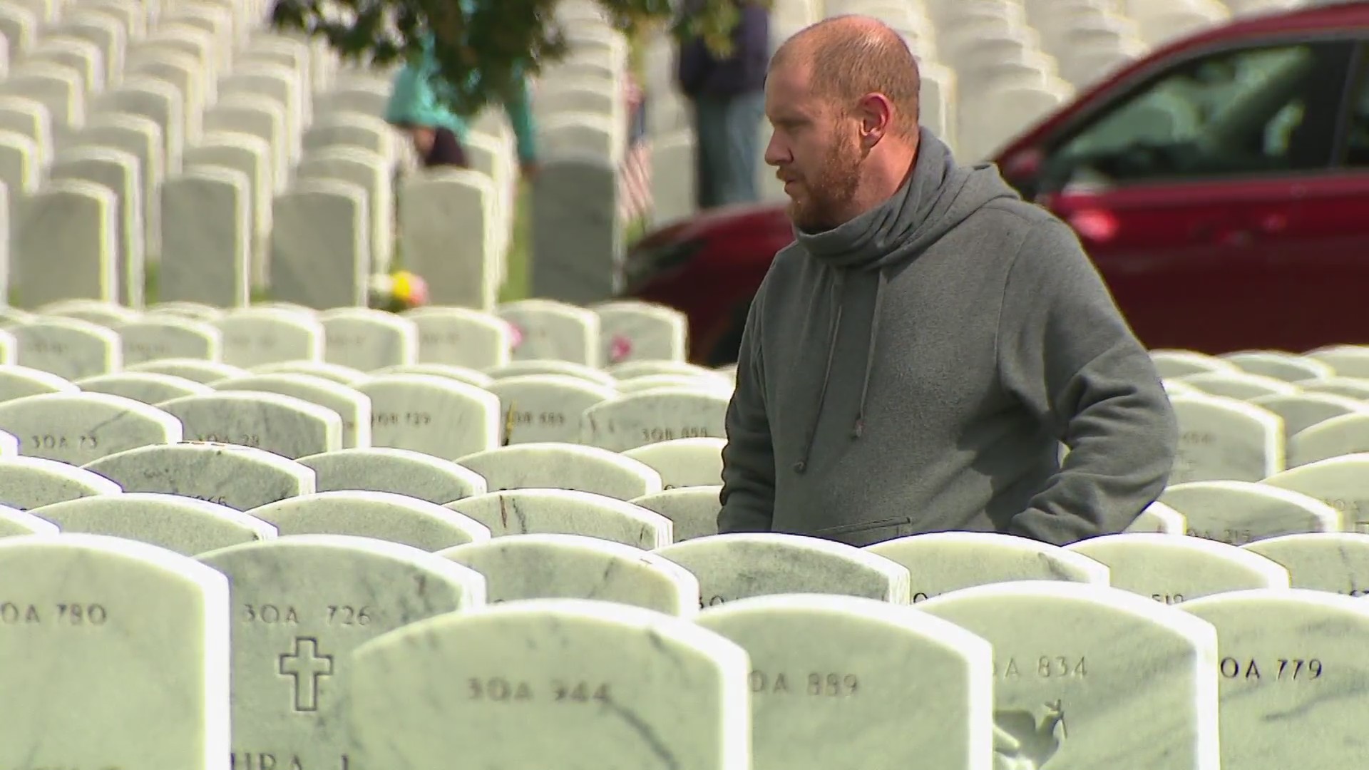 Family members of people buried at Fort Logan National Cemetery gather ...