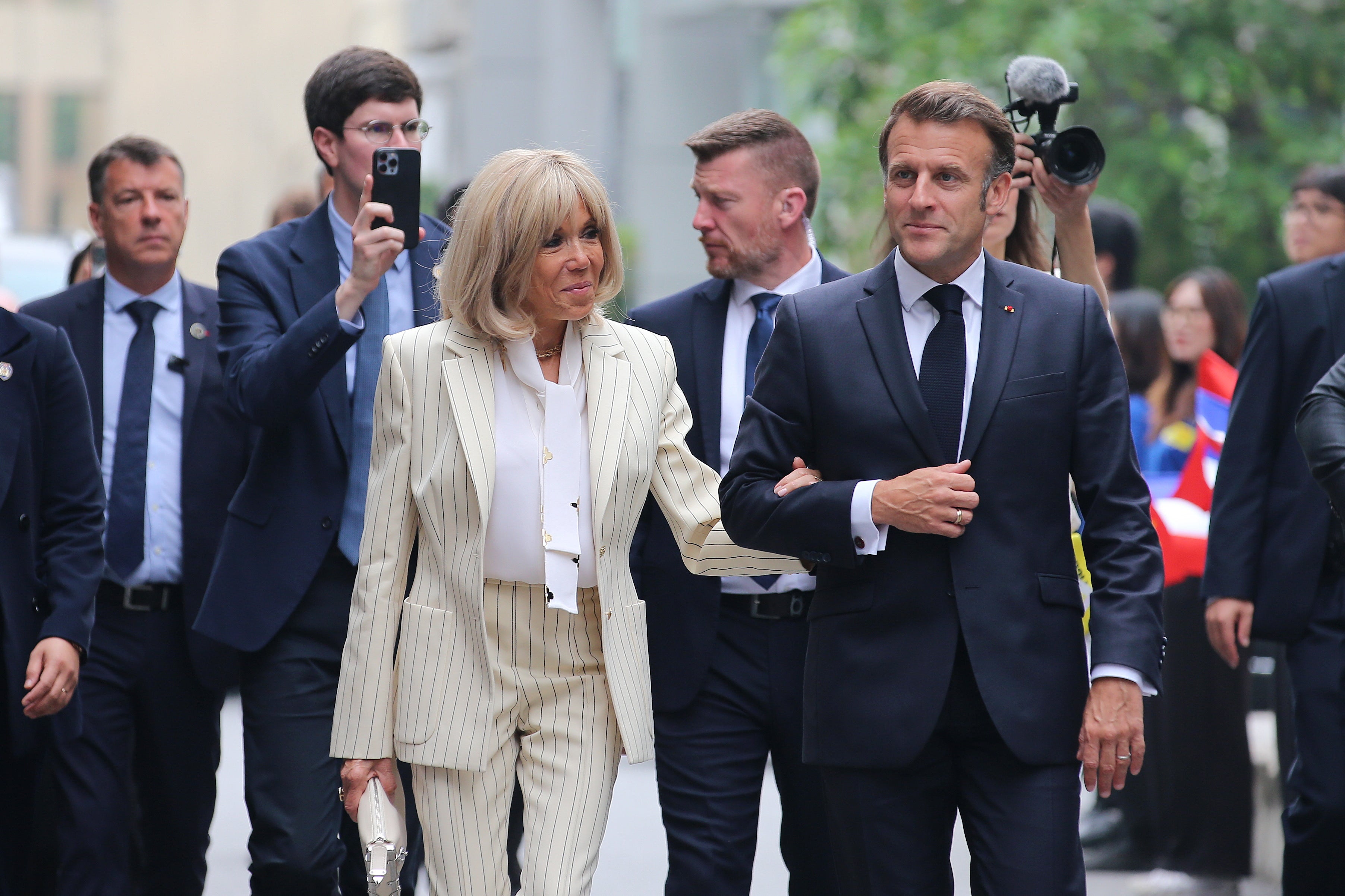 Emmanuel Macron and wife Brigitte all smiles and hand holding as they ...