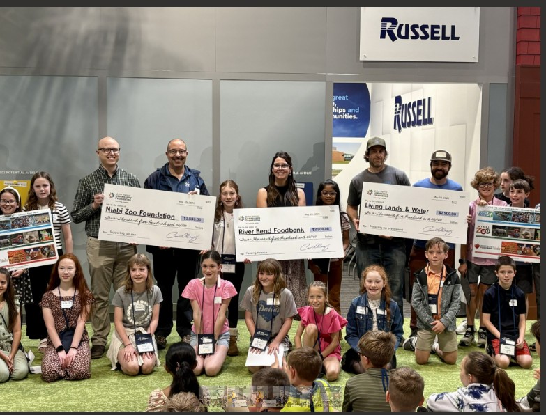 Junior Achievement students give checks to three QC nonprofit groups