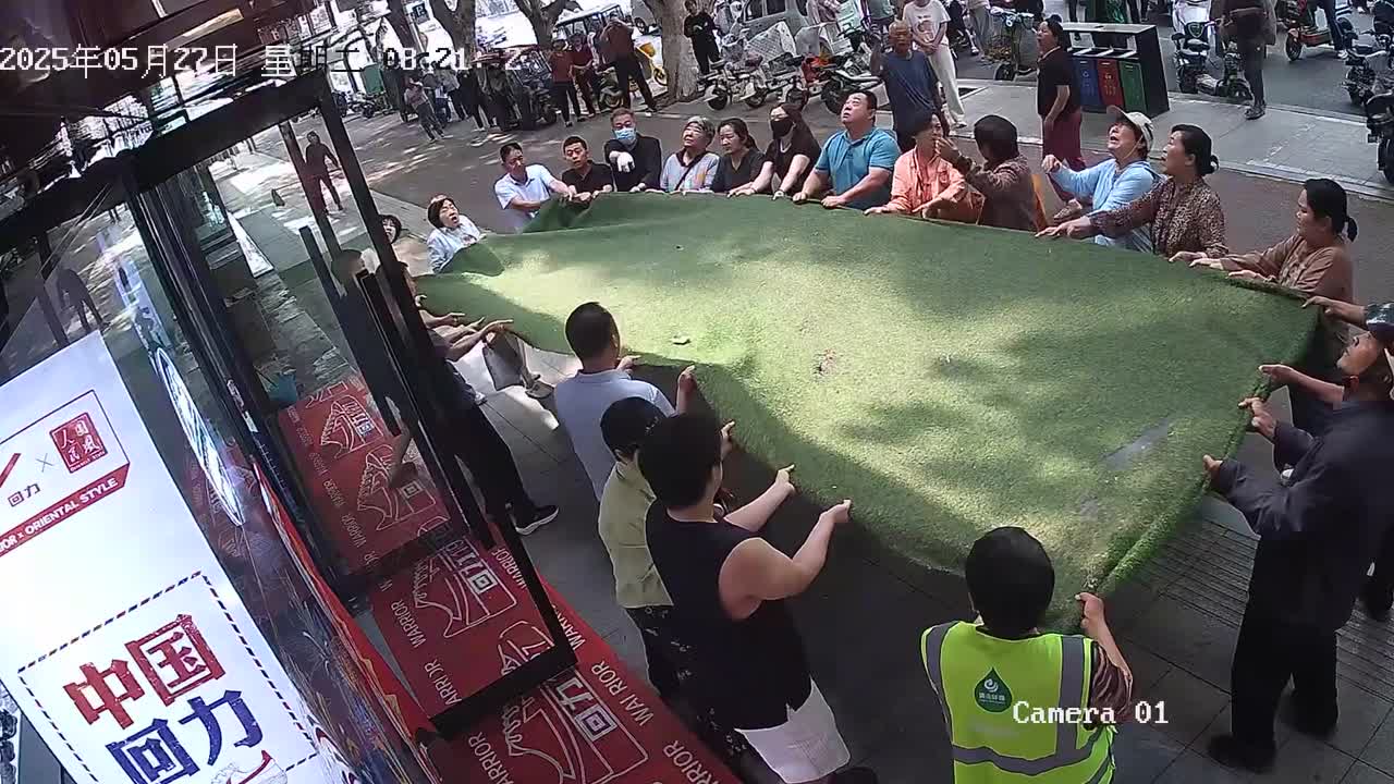 Residents hold mat to catch 102-year-old woman falling from building