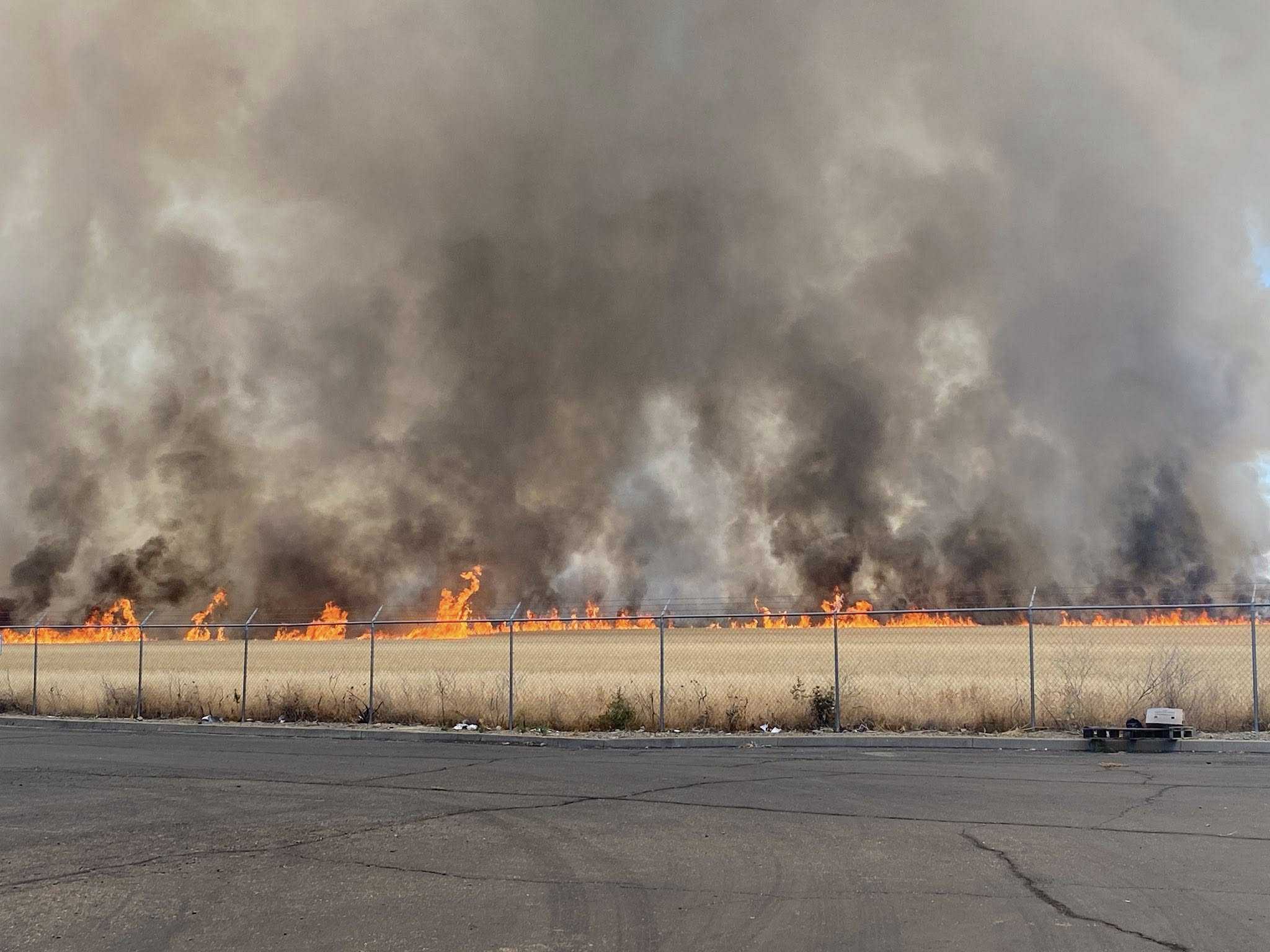 Woodland road closed after grass fire jumps containment line