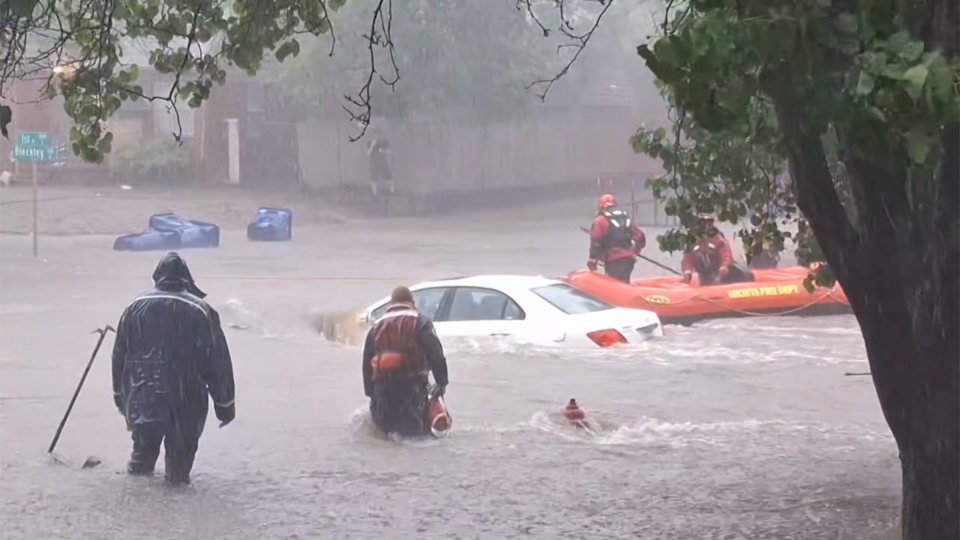 Cars and roads submerged in water during record rainfall in Kansas