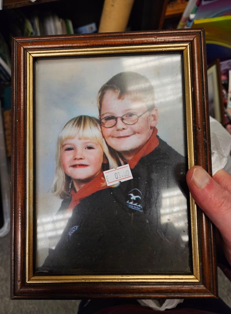 Siblings reunited with school photo found in charity shop 300 miles away