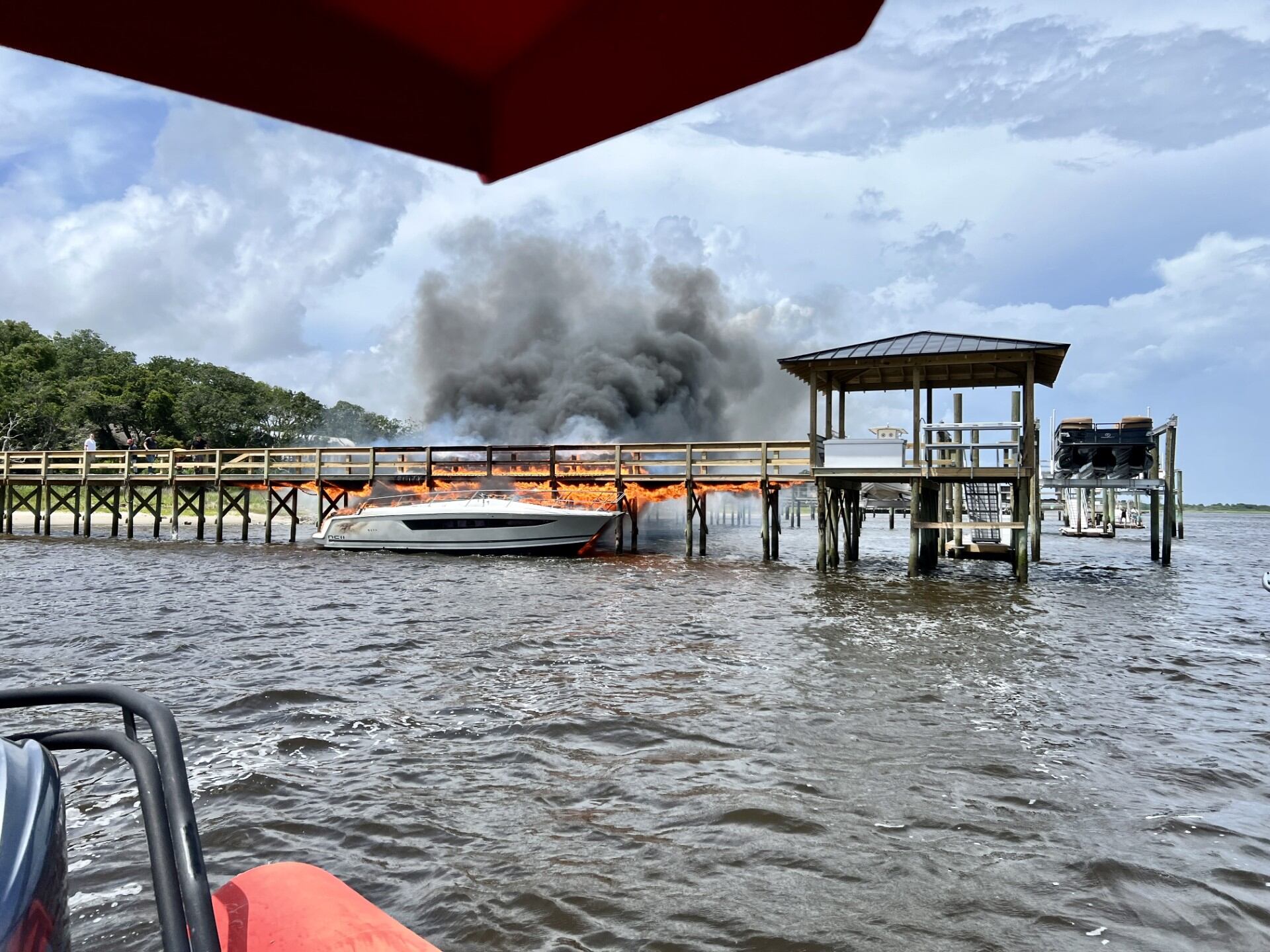 Crews extinguish boat fire at a private dock by the Carolina Beach Inlet