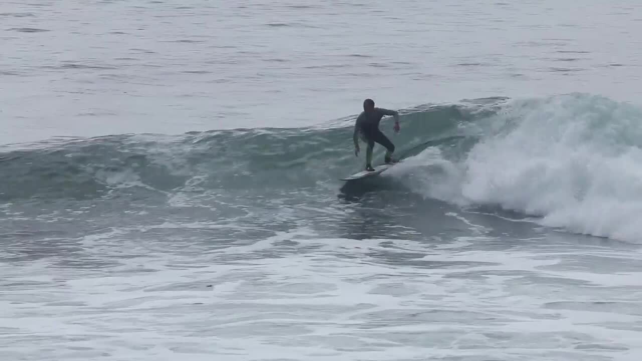 Surfer Shreds Waves and Performs Tricks