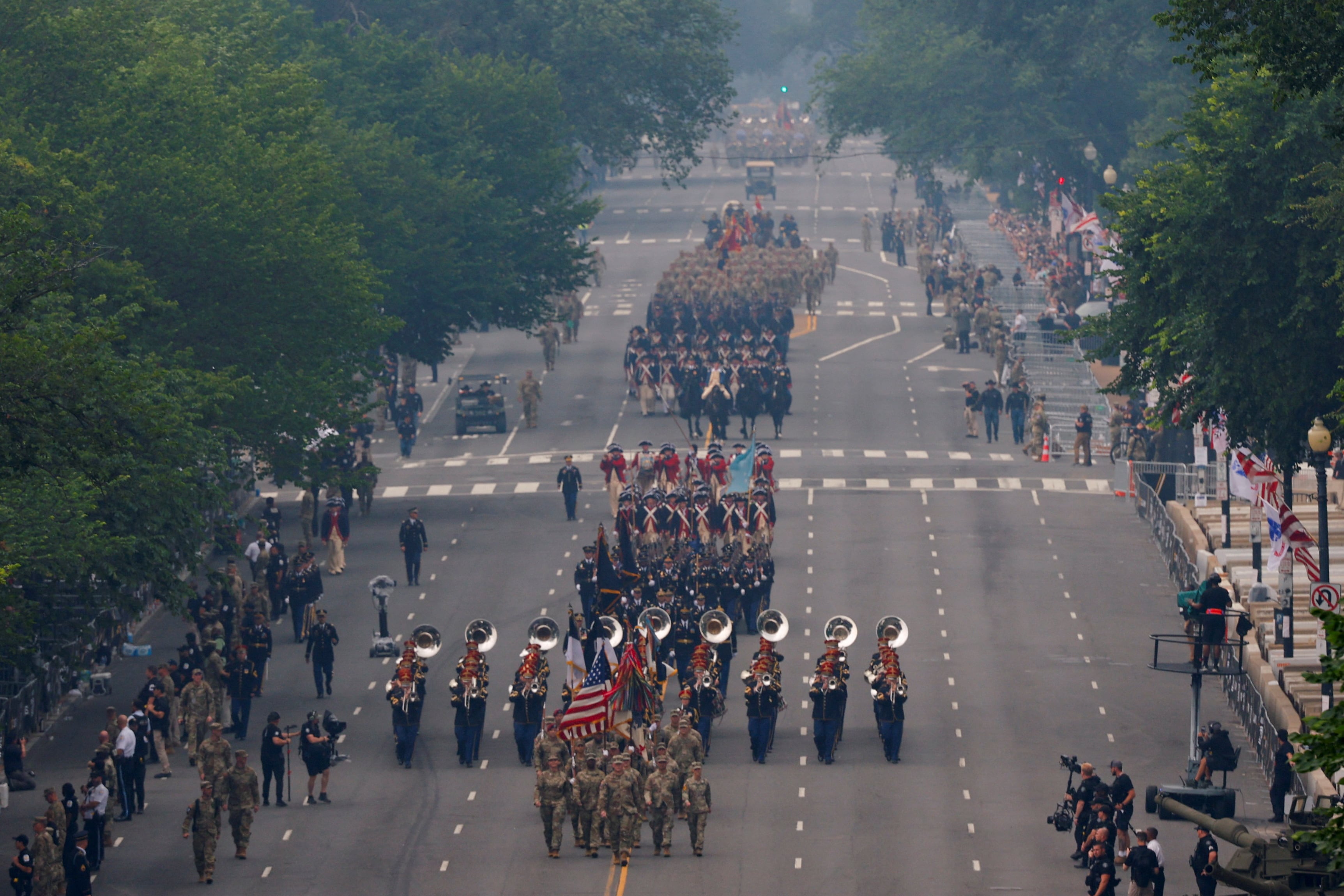 Rain Forces Trump to Rush 79th Birthday Parade Past Empty Bleachers