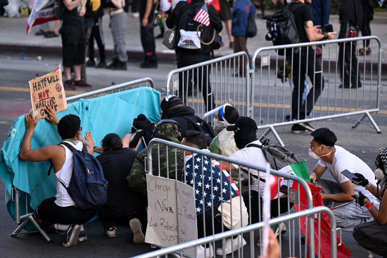 Police deploy stun grenades, rubber bullets, tear gas on L.A. protesters