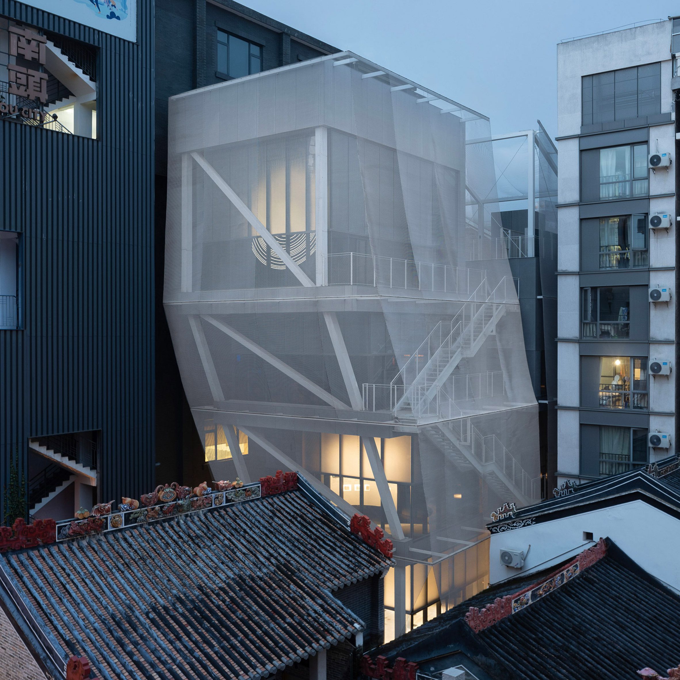 Ten ethereal buildings screened by ghostly metal mesh