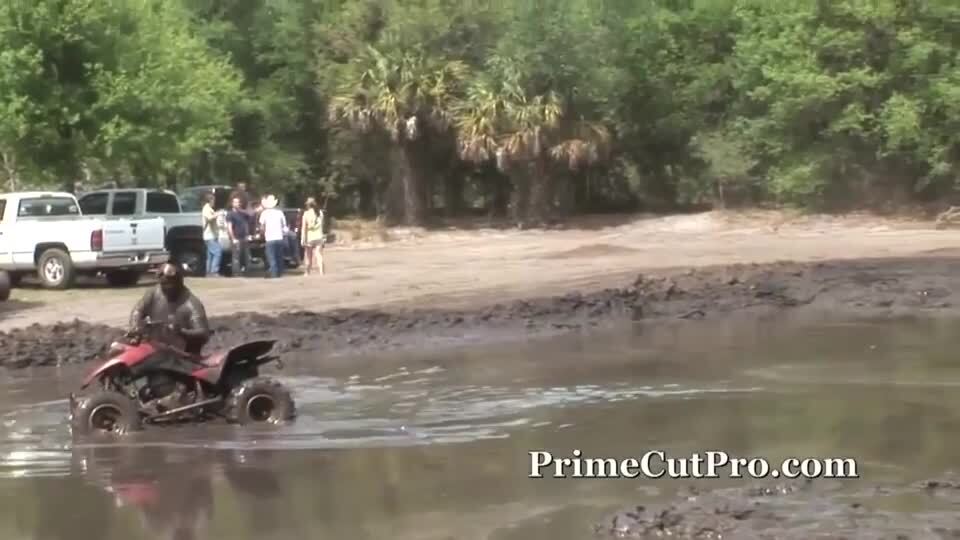 Man Driving ATV Falls into Mud