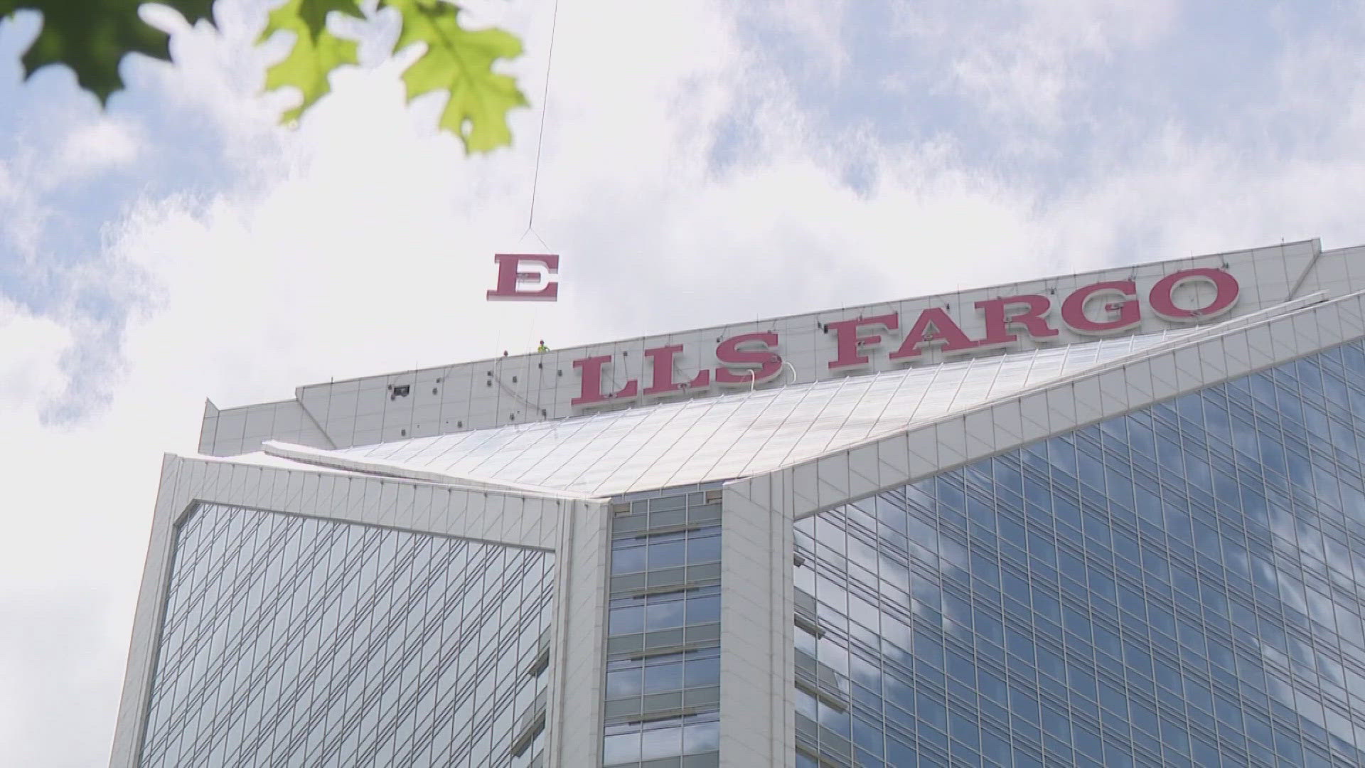 Crews install Wells Fargo sign in Uptown Charlotte