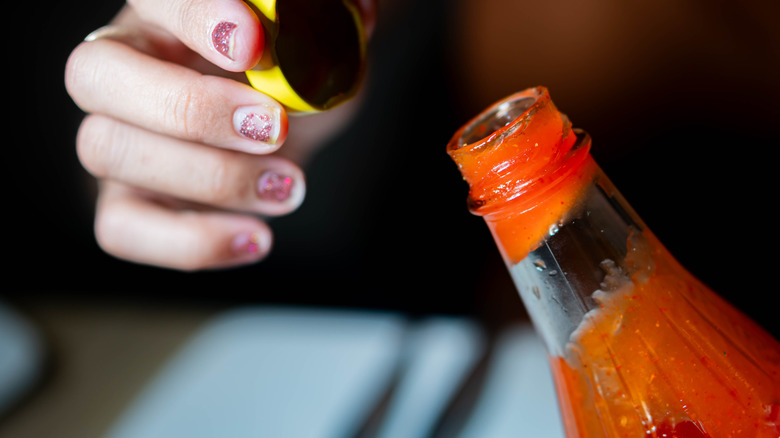 A Clever DIY That Turns A Hot Sauce Cap Into A Statement Drawer Knob