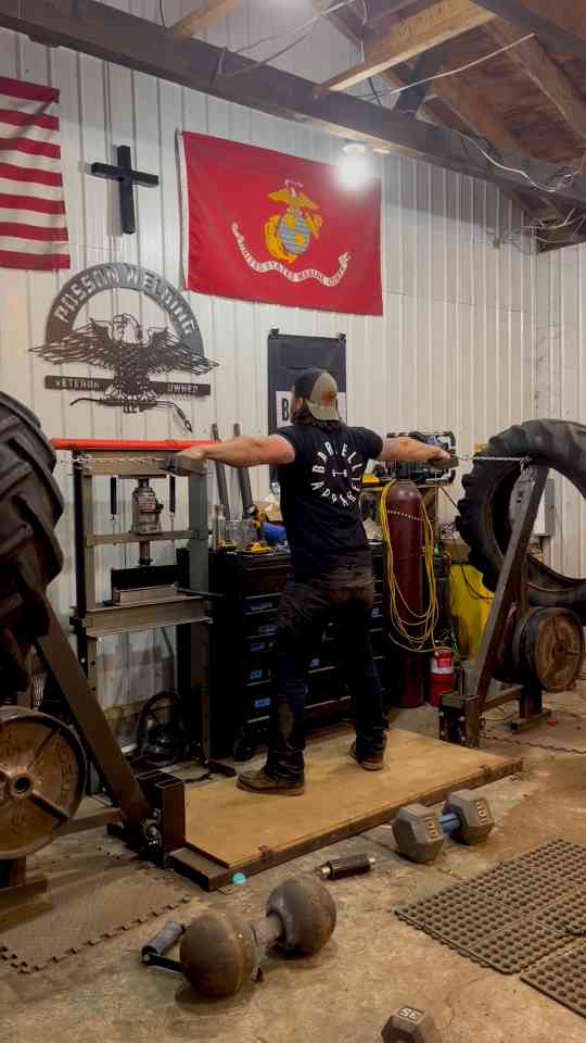 Strongman Practicing Hercules Hold with Custom Equipment in Gym