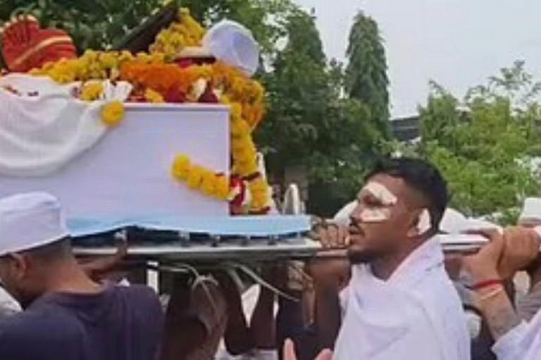 Air India crash survivor carries brother's coffin at funeral in ...