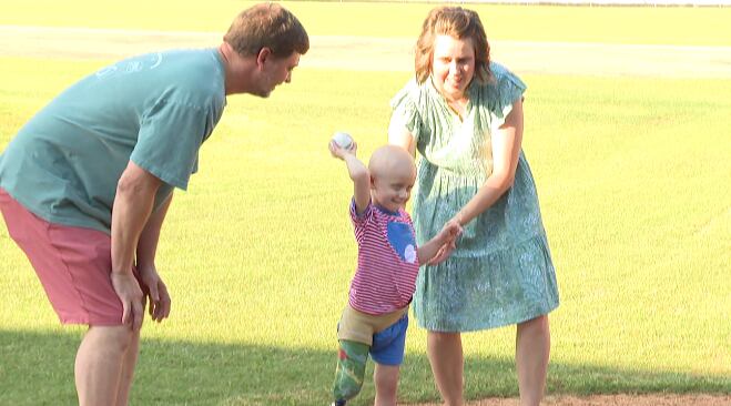 Young cancer-survivor, Lewis Anderson, throws out the first pitch to ...