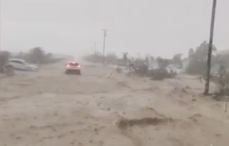 California Hail Storm Leaves Car Struggling To Drive Through Flooded Road