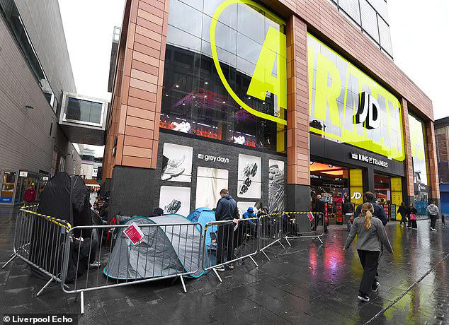 Teenagers camp out and brave 15 hour queues in the pouring rain to get ...