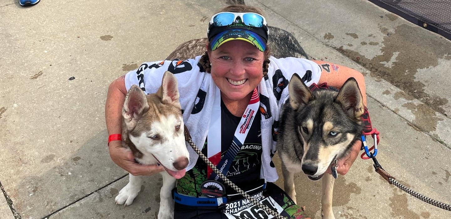 She’s completed 99 Ironman races. Her motivation? Petting dogs mid-race.