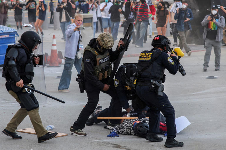 Live updates: Tear gas fired at protesters outside federal building in ...