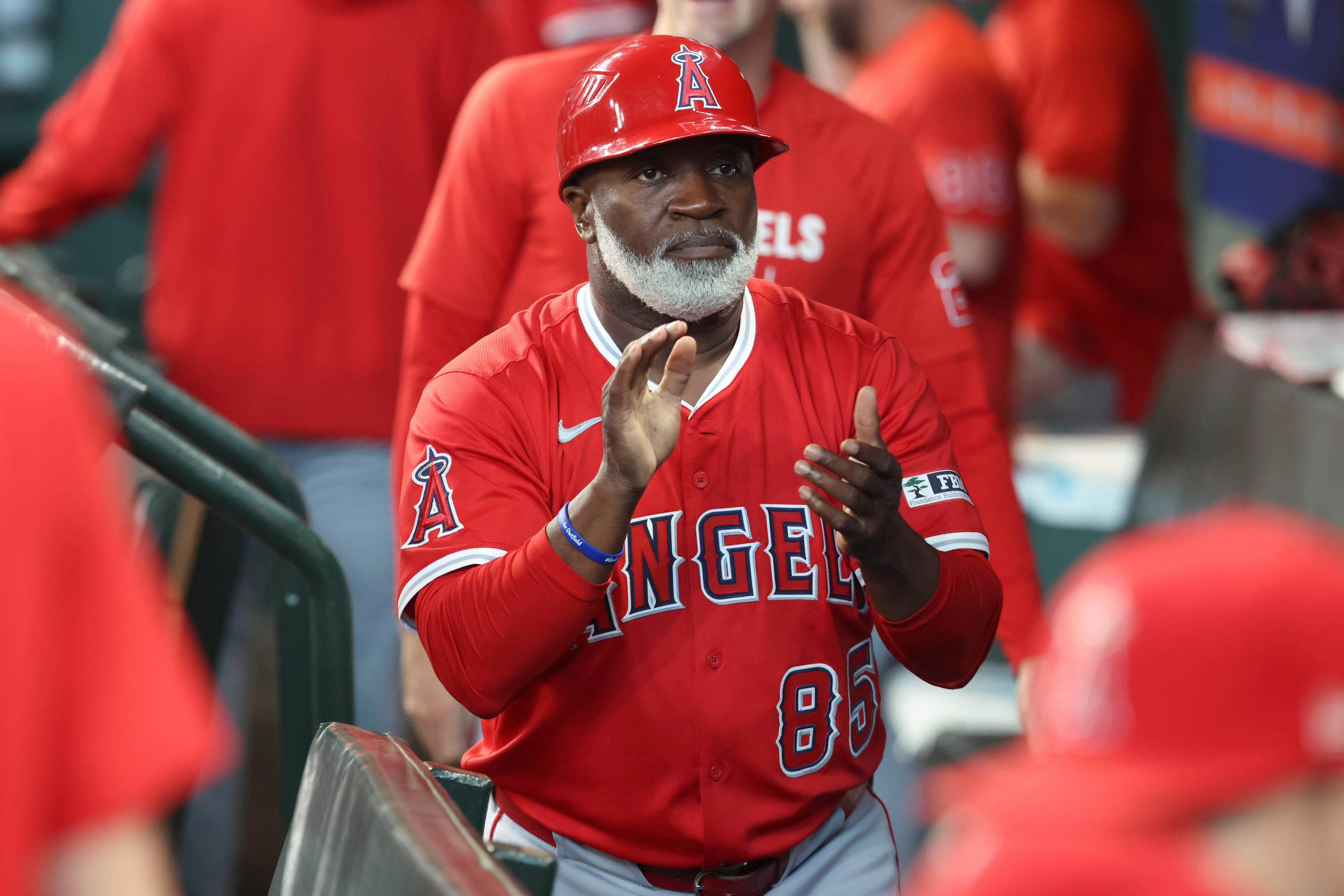 Angels coach Eric Young Sr. tossing snacks to son Eric Jr. on Mariners ...