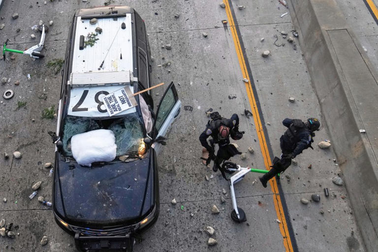 Video: Protesters throw rocks at highway patrol officers from LA ...