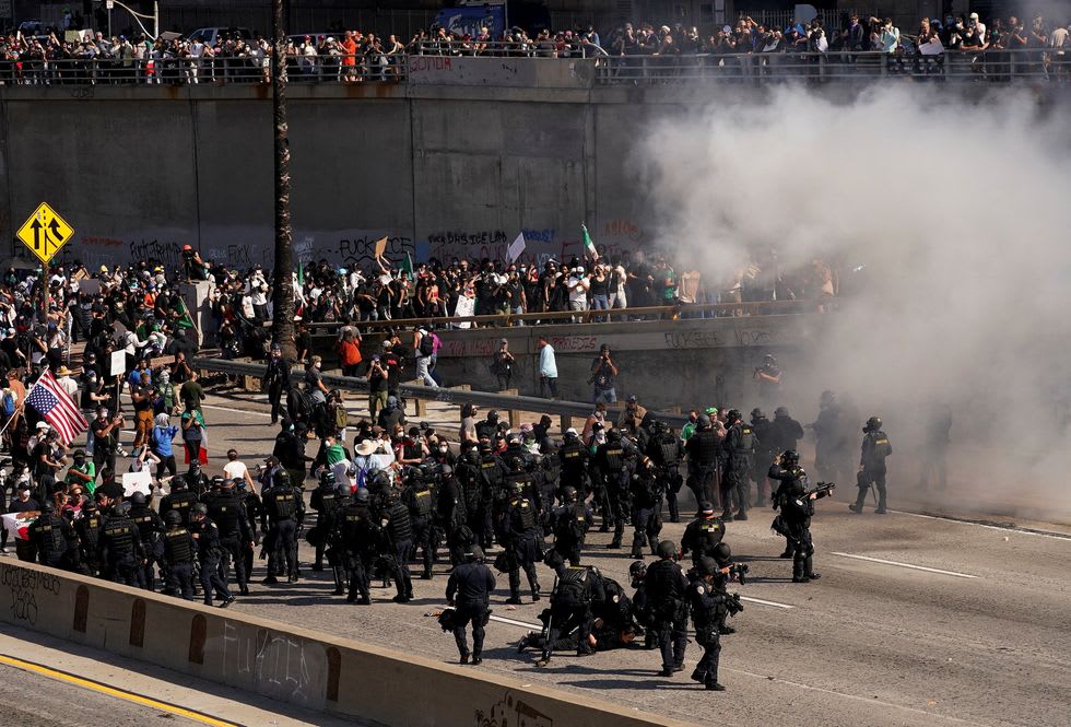 Los Angeles riots: Police throw tear gas at protesters as streets erupt ...