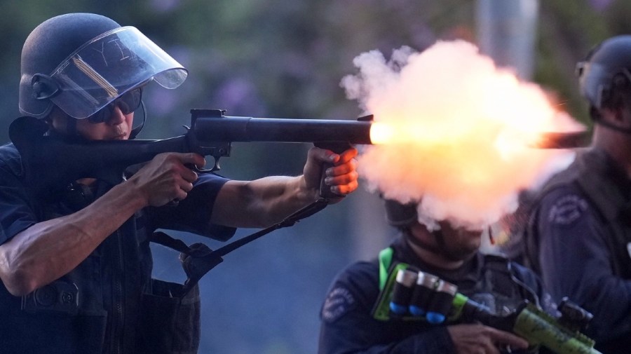 Reporter hit as LA officers fire rubber bullets at protesters
