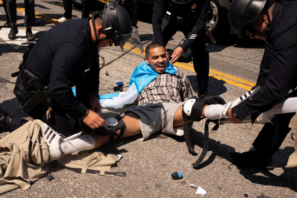 LAPD takes down protester on stilts, drags him away at an anti-ICE riot