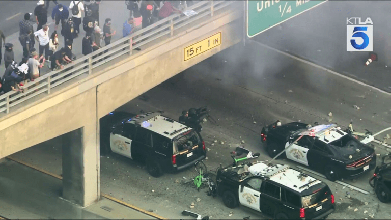 Video: Protesters throw rocks at officers from LA freeway bridge