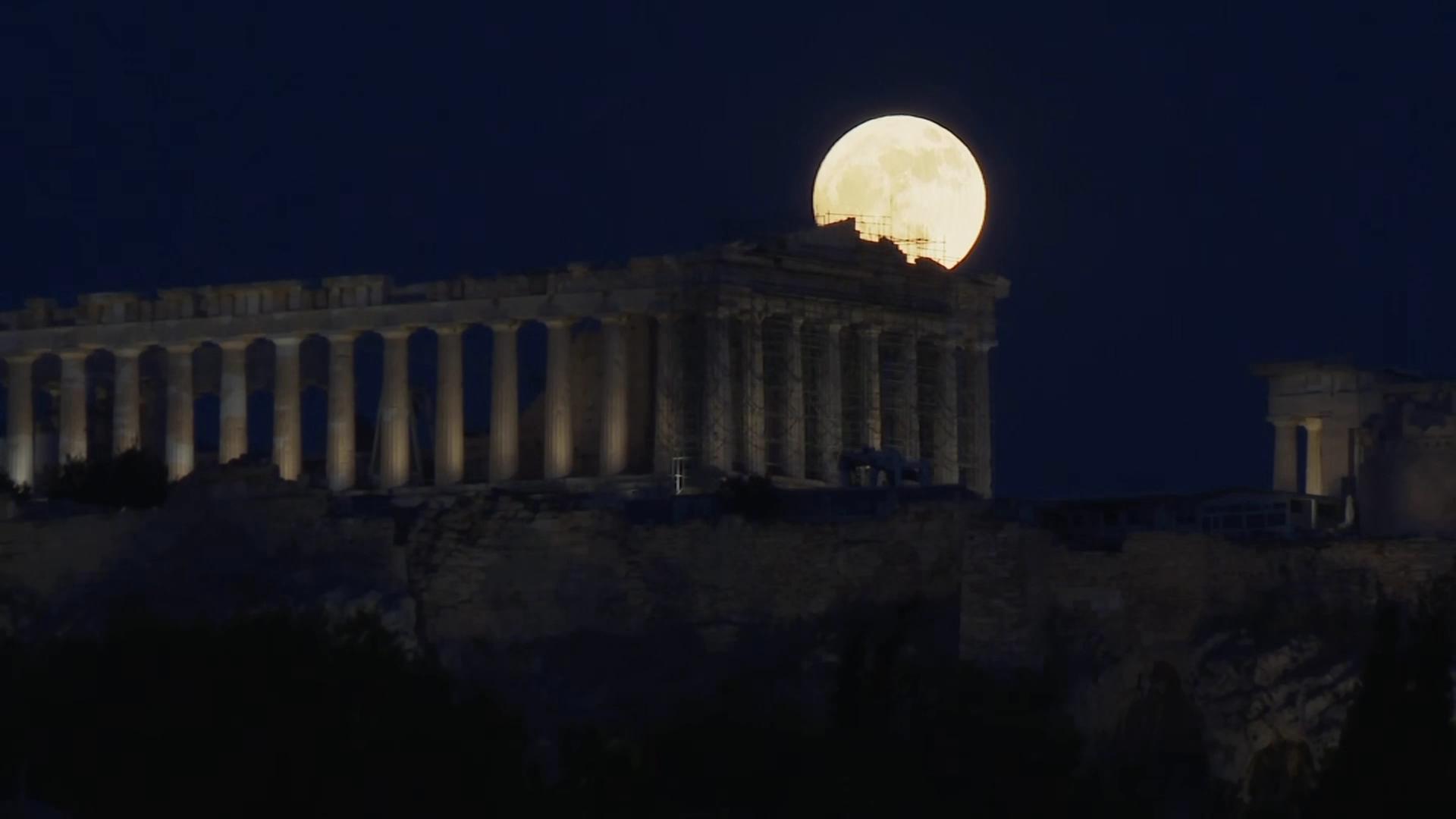 Strawberry moon rises behind the Parthenon in Athens