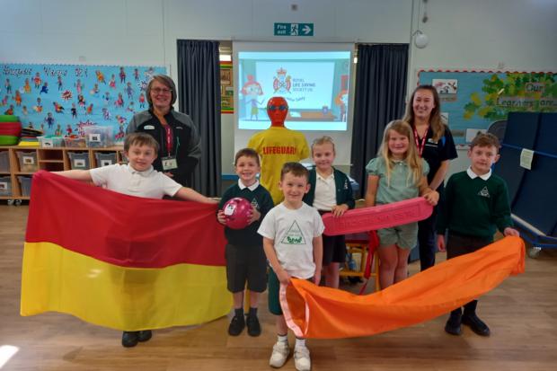 Swimming teachers deliver water safety assembly at school