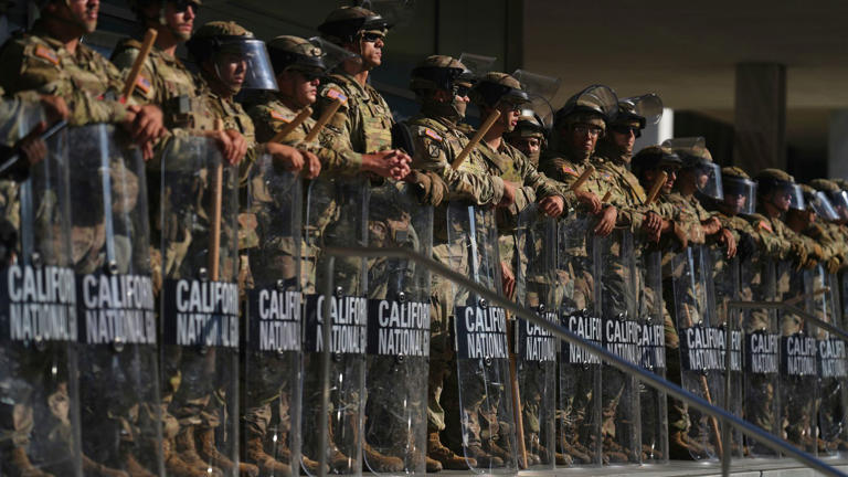 Riot police enforce LA curfew as protests spread across US