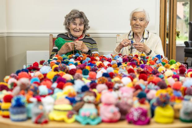 Care home residents and staff knit 500 hats for charity