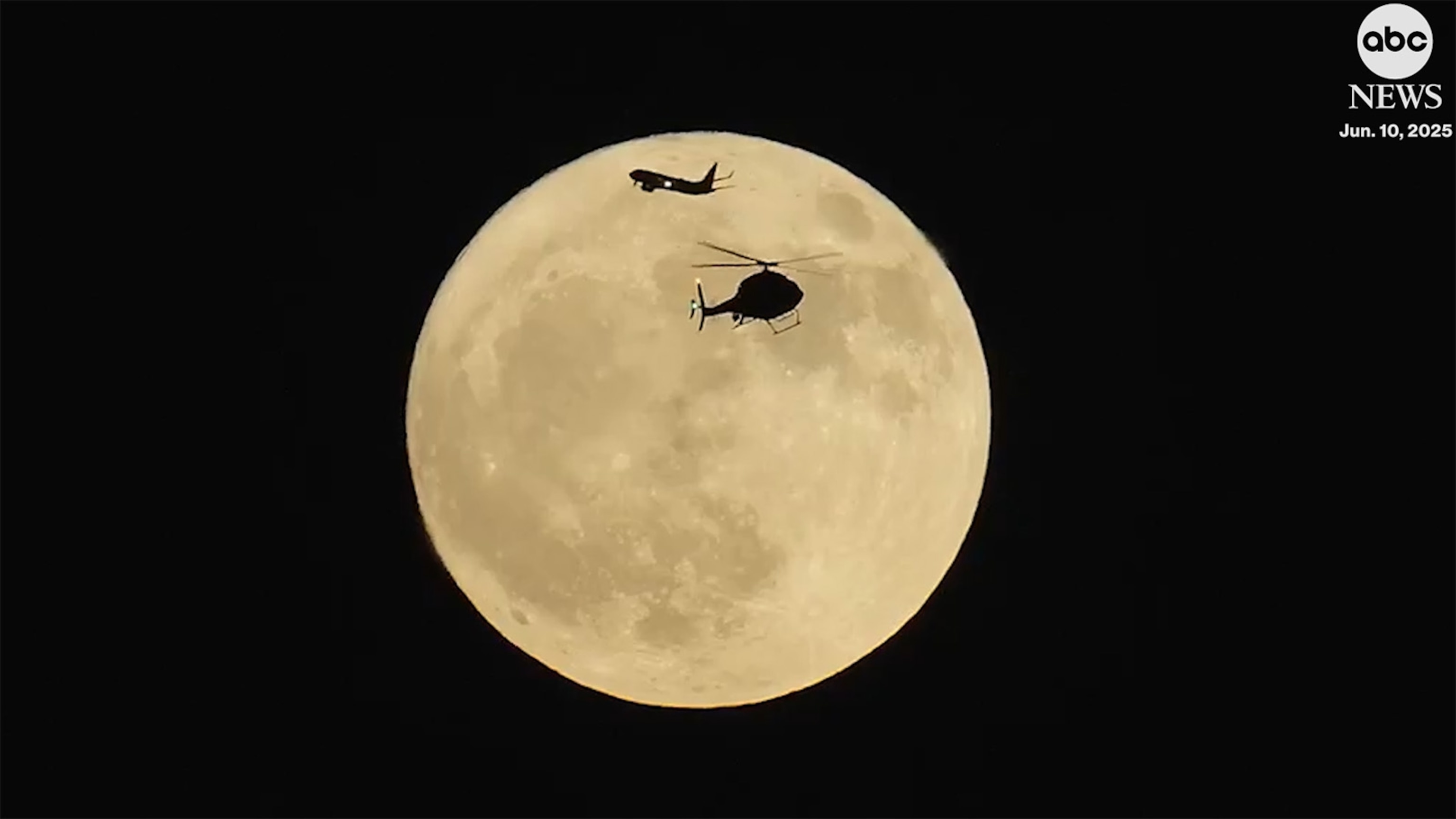 Stunning moment helicopter and plane pass in front of 'strawberry moon ...