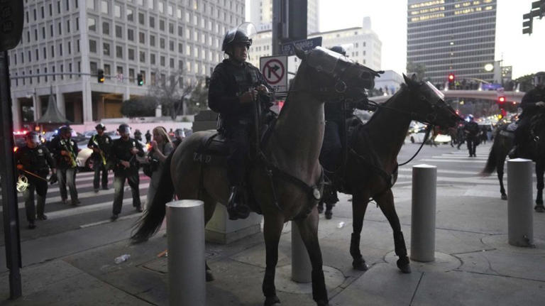 Police officer confronts CNN reporter in LA: ‘You grabbing me?’
