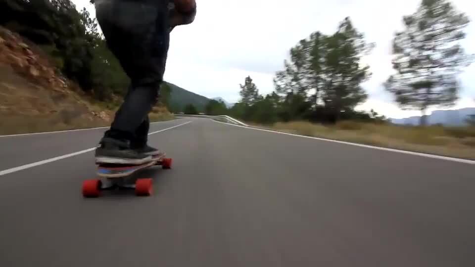 Longboard Rider Cruises and Makes Sparks With His Hands