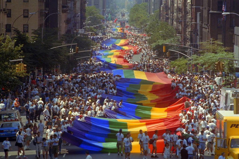The original rainbow pride flag had 8 stripes. So why did two colors ...
