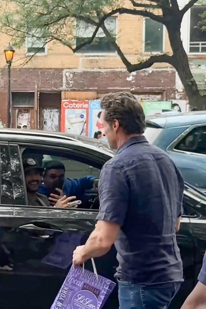 Watch Hugh Jackman jump into stranger’s car to escape chaotic mob of fans