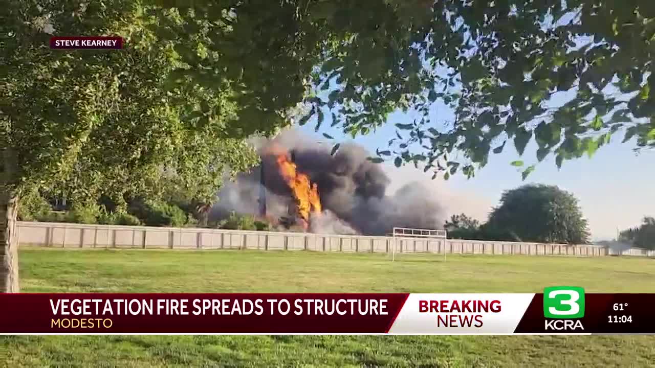 Modesto vegetation fire spreads to structures, officials say