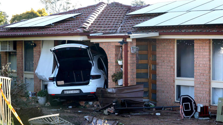 SUV crashes into house, lands on bed