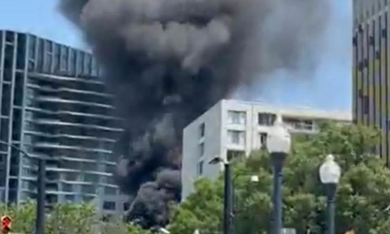 Car explodes in Washington DC as black smoke billows through sky