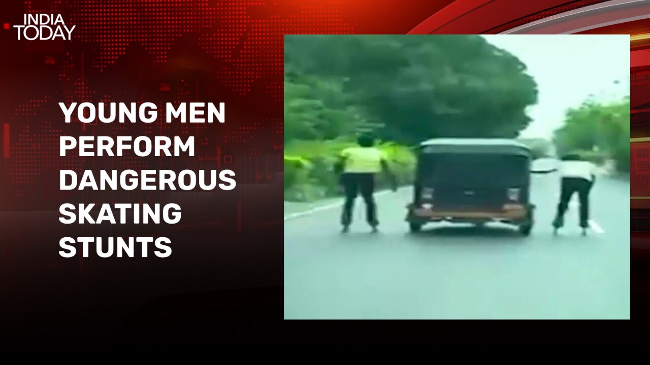 Video: Young men perform skating stunts by holding onto moving auto ...