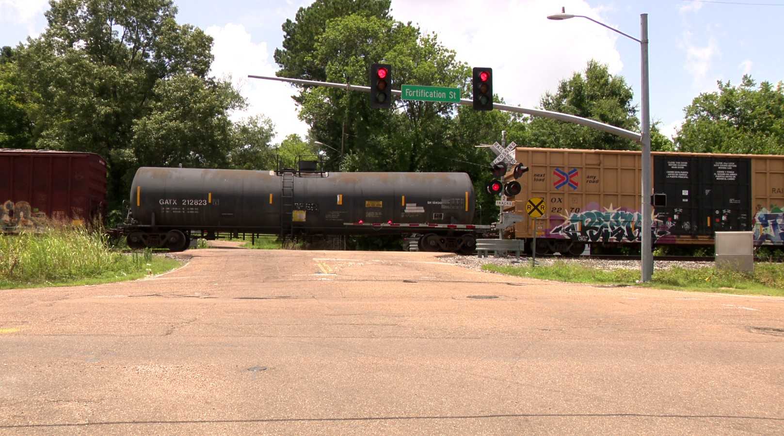 Train cars blocking neighborhood railroad crossing