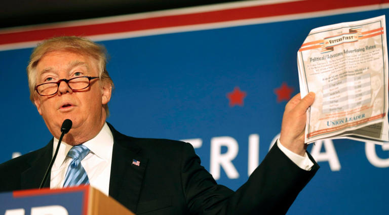 Donald Trump caught wearing glasses and reading paper