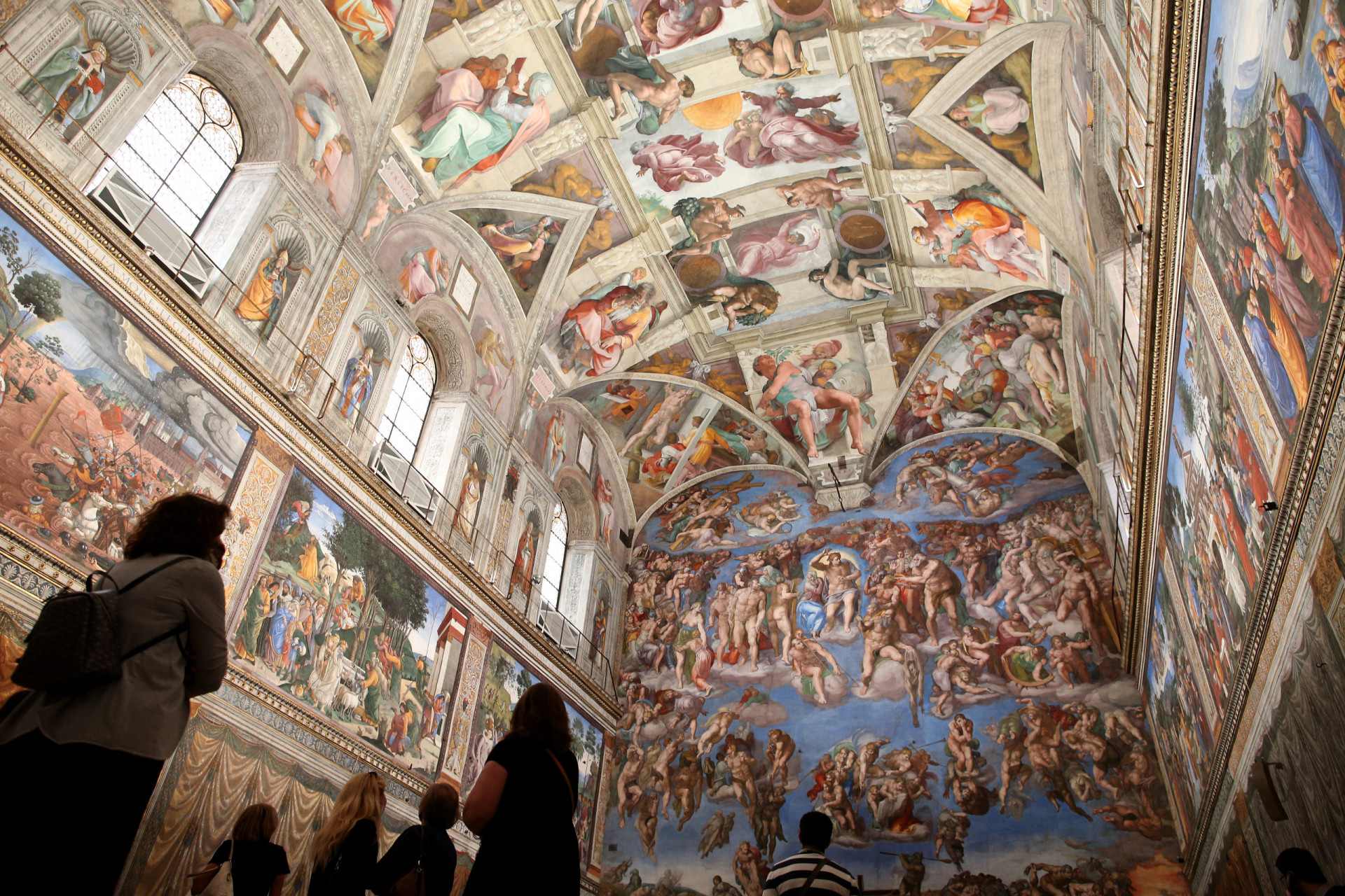 What is painted on the ceiling of the Sistine Chapel?